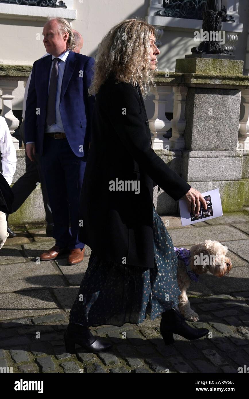 Charlie Bird's wife Claire with his dog Tiger leaves after a service at ...