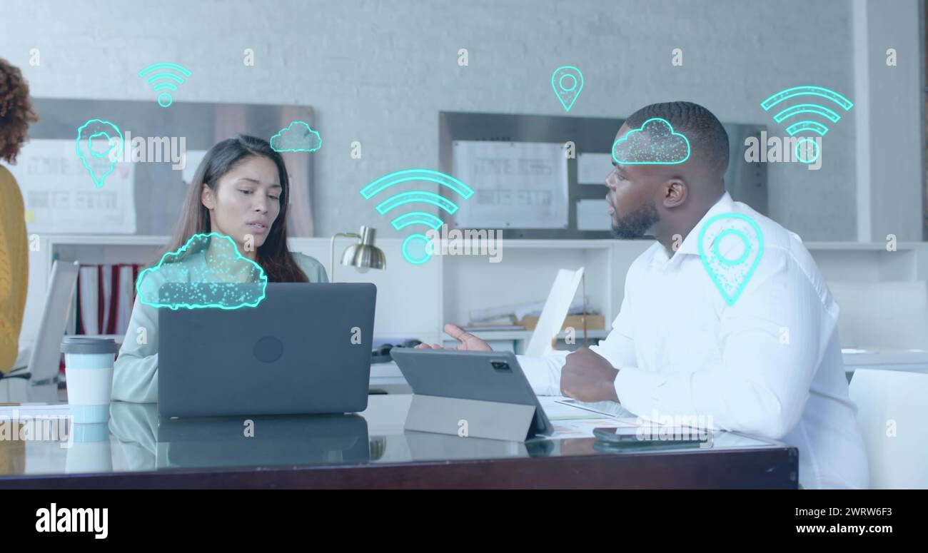 Digital communication icons over diverse female and male colleague at ...