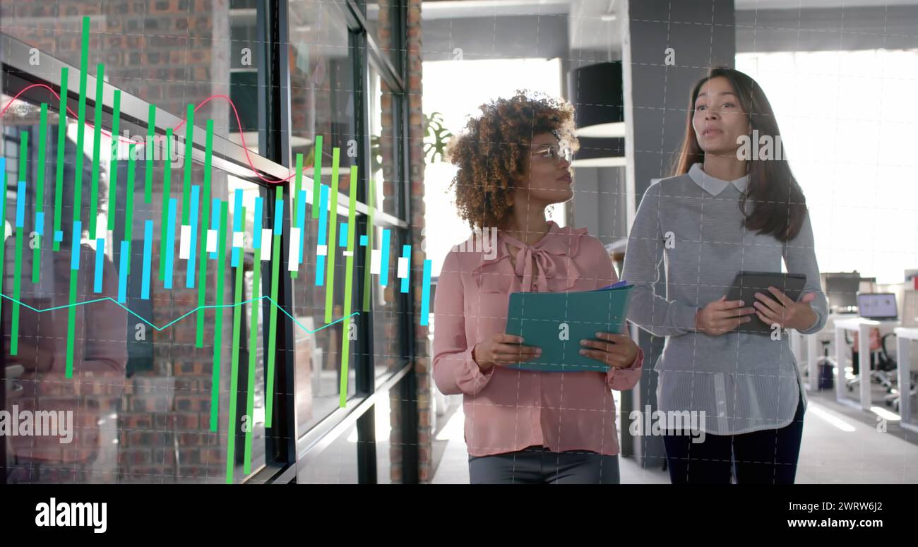 Graphs processing data over diverse casual businesswomen talking in ...
