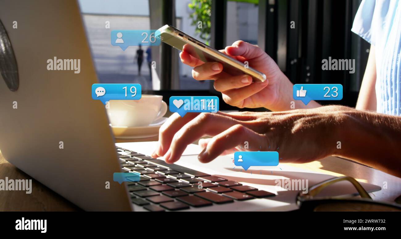 Image of social media icons falling over person using laptop Stock ...
