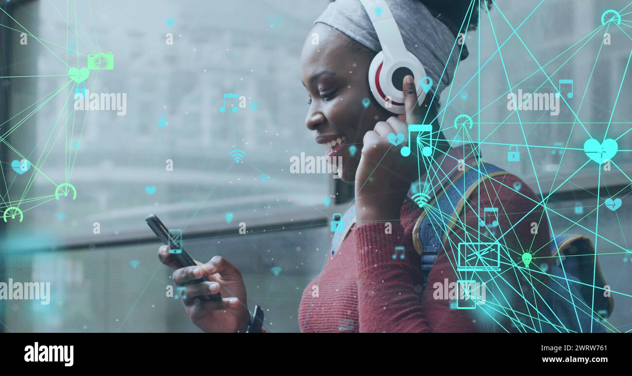 Image of connected media icons over happy african american woman using ...
