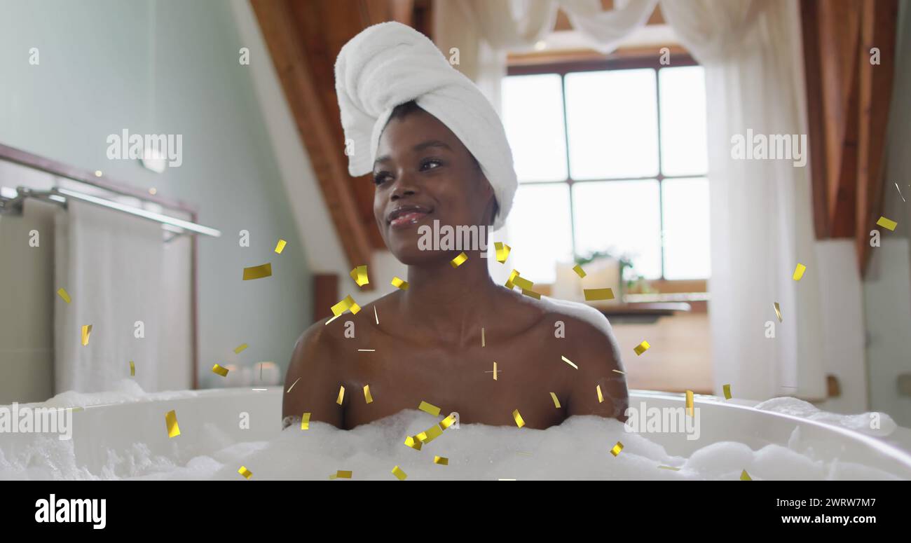 Image of gold confetti falling over happy african american woman ...