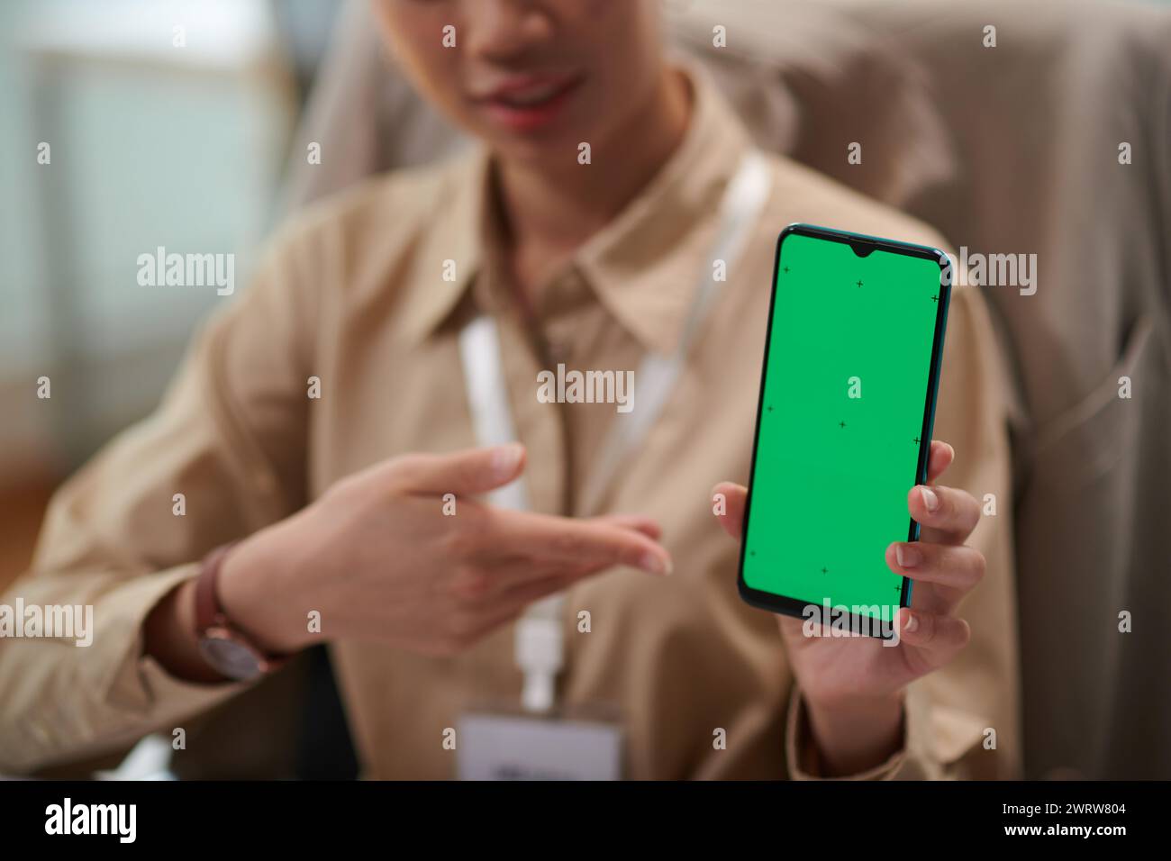 Banking manager showing new application on smartphone, green screen ...