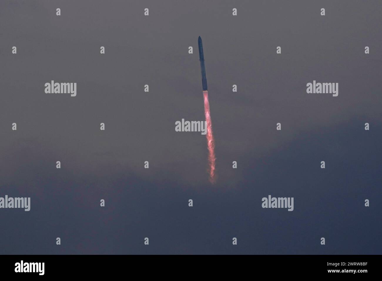 SpaceX's mega rocket Starship cuts through clouds and haze on it's ...