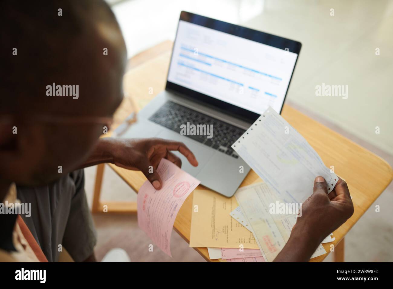 Black man checking utility bills in the end of month Stock Photo - Alamy