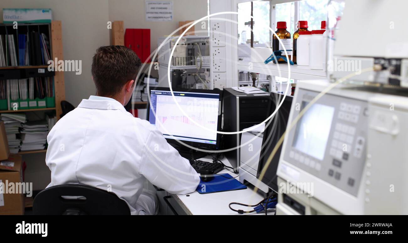 Image of circles spinning over male scientist using computer Stock ...