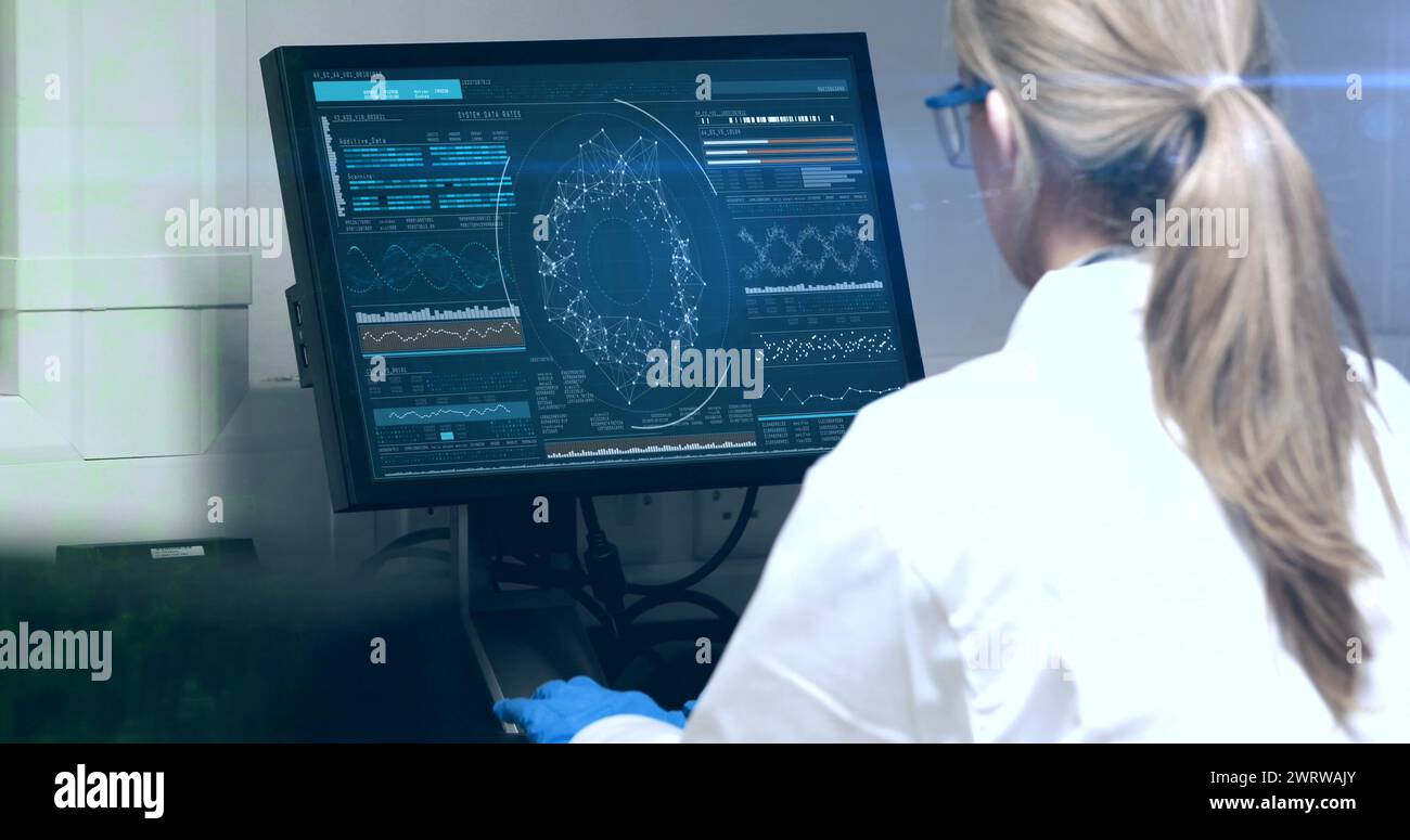 Image of human brain spinning over female scientist using computer ...