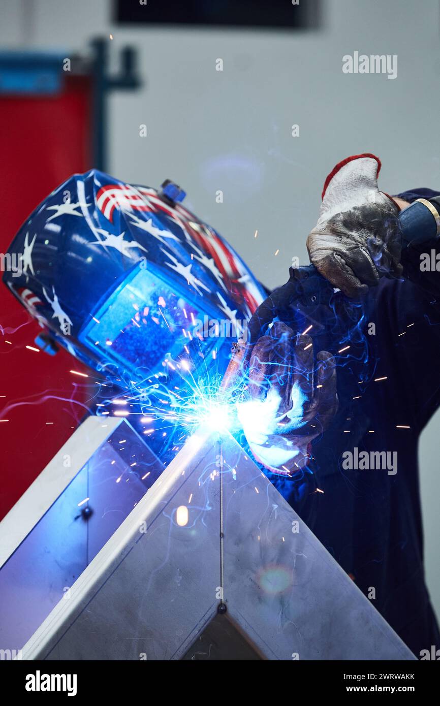 Welder spot welding a metal angle with sparks flying Stock Photo - Alamy