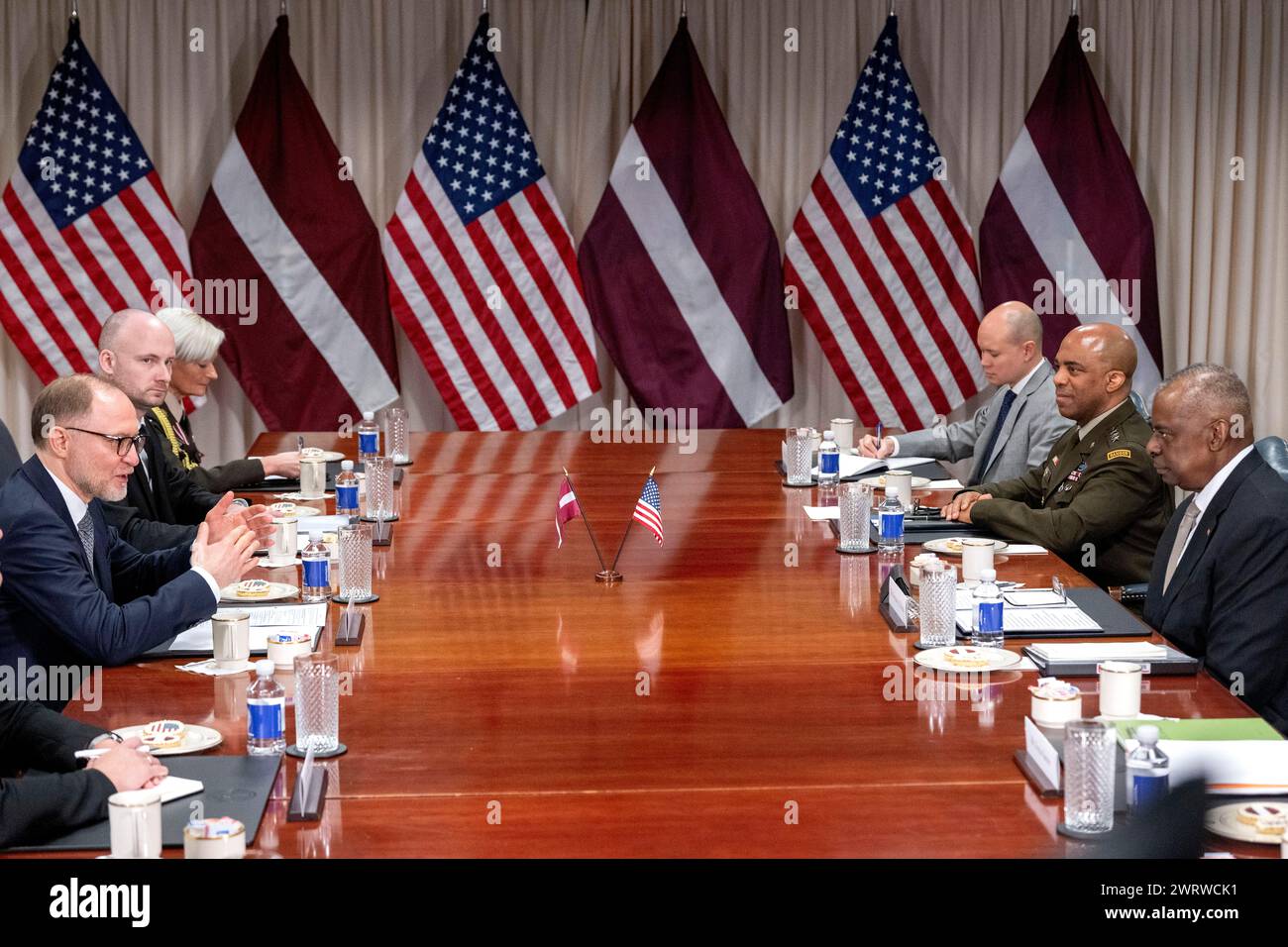 Latvian Defense Minister Andris Spruds, left, speaks during a meeting ...