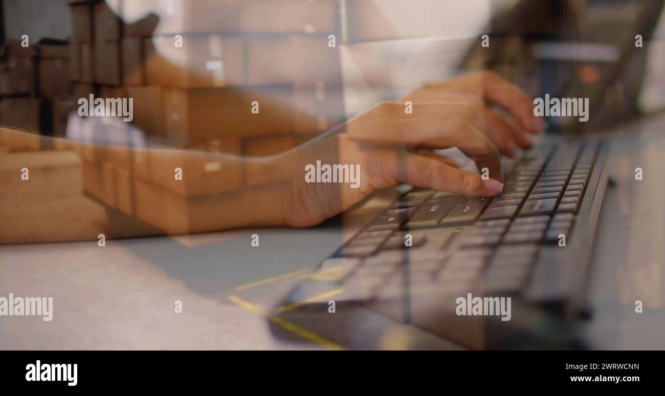 Image of person typing on computer keyboard with stacks of boxes in ...