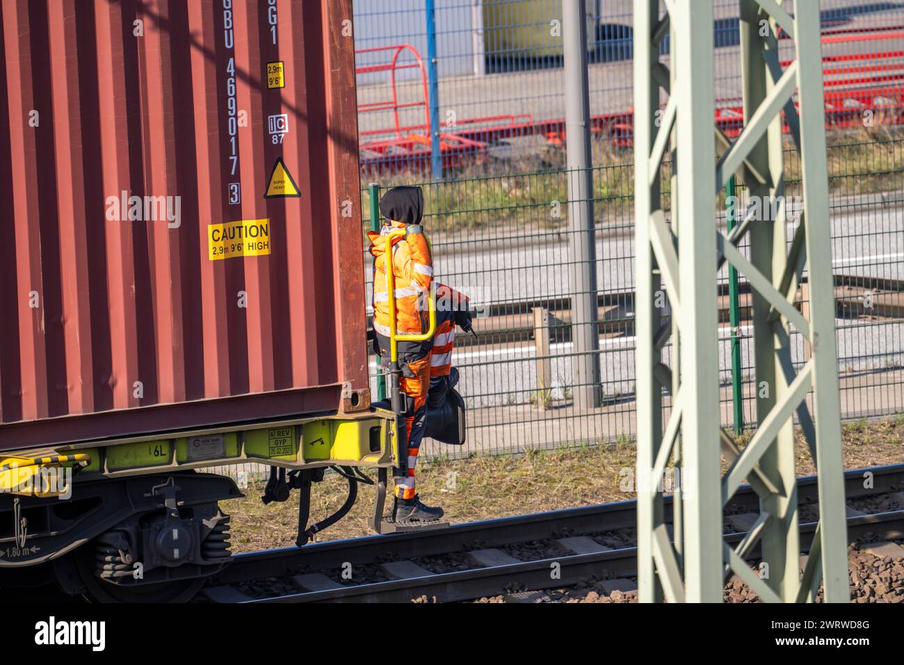 Shunter, railroad employee steers the freight train with containers ...