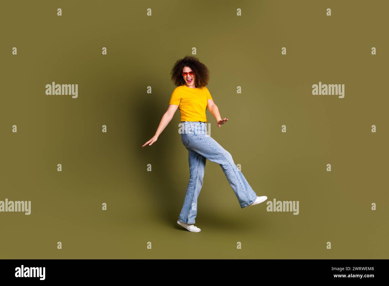 Full length body photo of excited girl in yellow t shirt and jeans ...