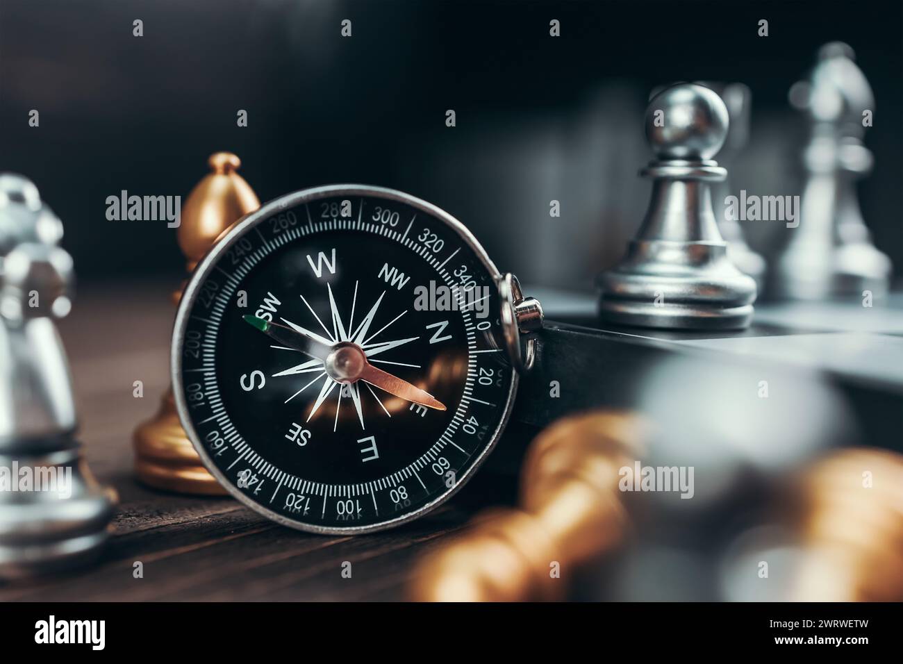 compass and chess piece on chess board game for ideas, challenge, leadership, strategy, business ...