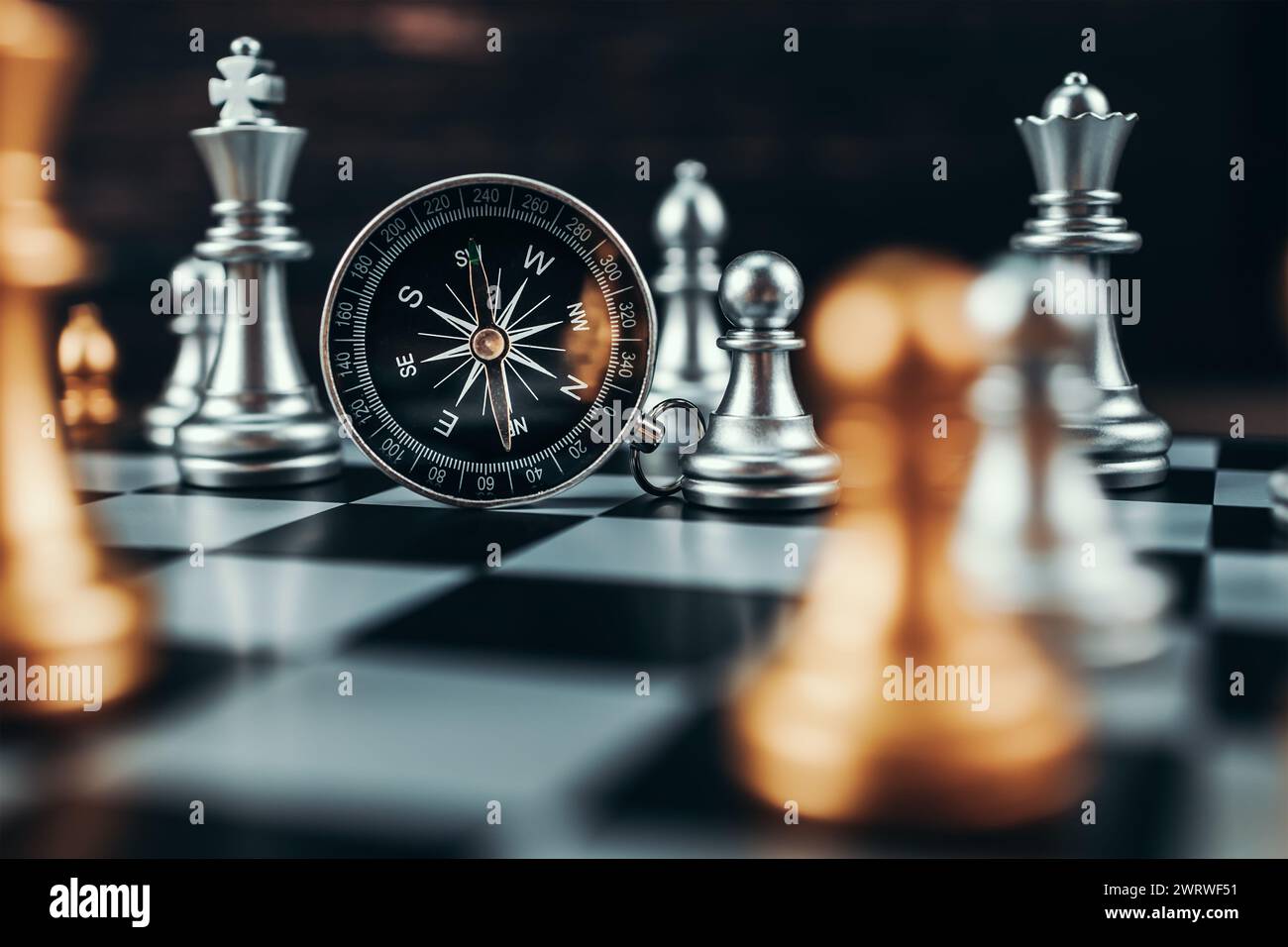 compass and chess piece on chess board game for ideas, challenge, leadership, strategy, business ...
