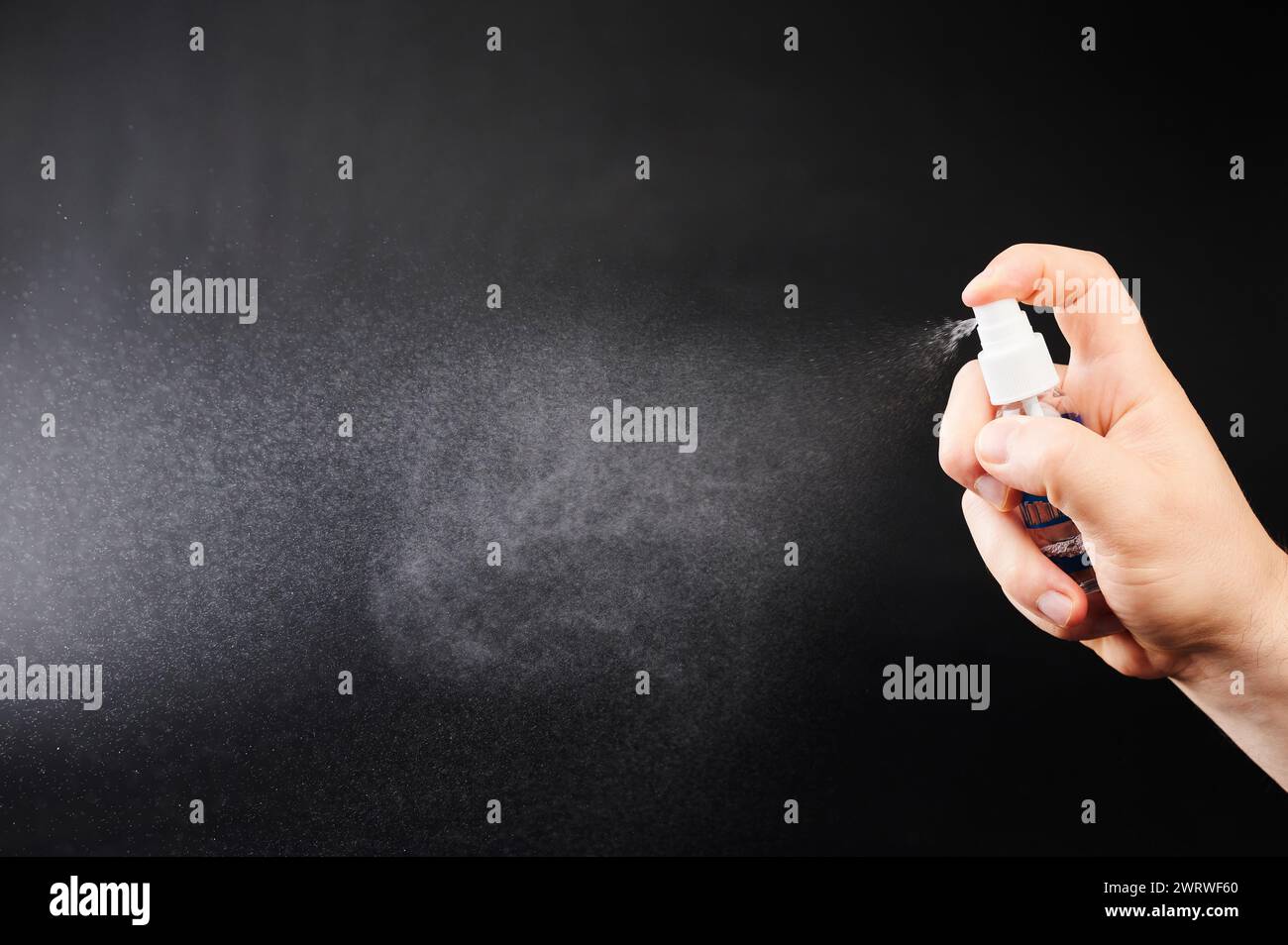 Hand hold small plastic spray bottle with many drop cloud isolated on ...