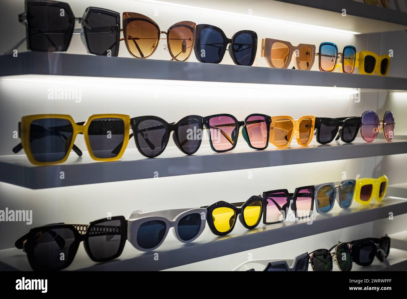 Storefront shelves of various modern sunglasses in retail store ...