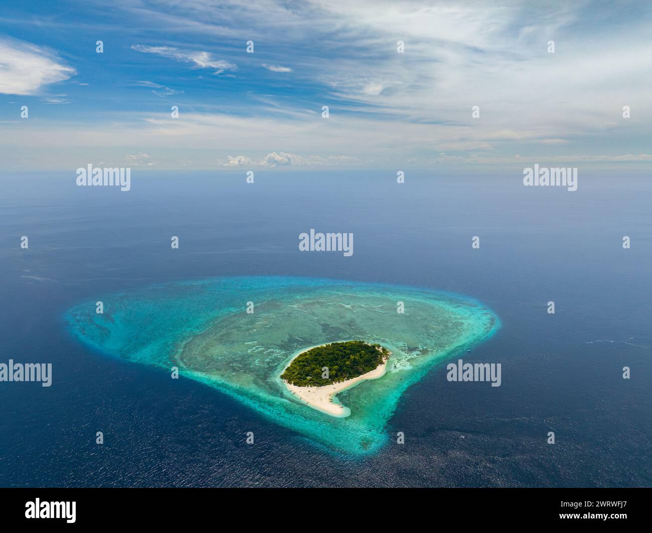 Mantigue Island with white beach and boats. Blue sea and coral reefs ...