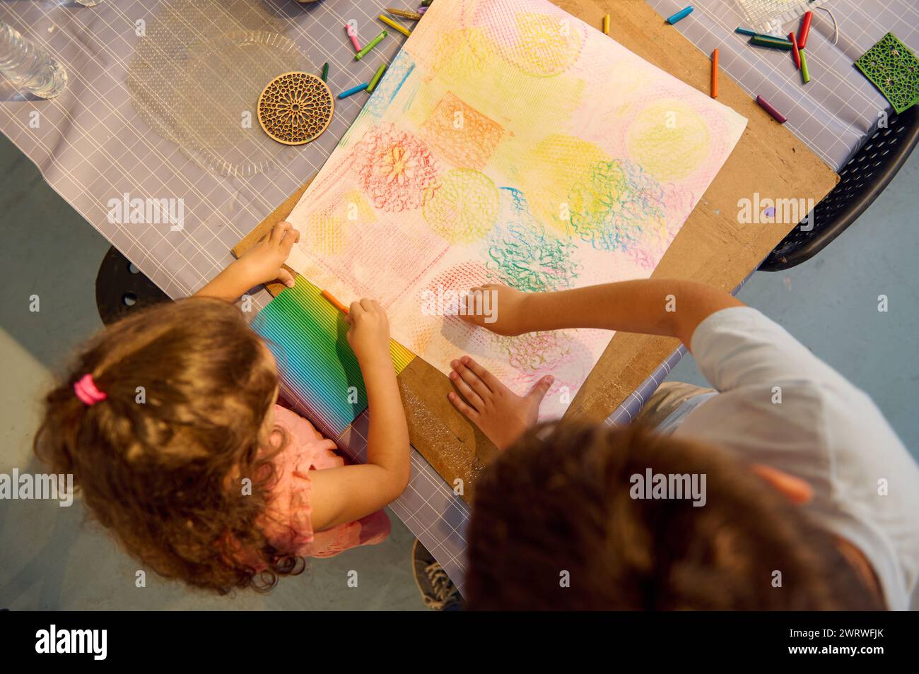 Overhead view of children, elementary age schoolkids drawing picture ...
