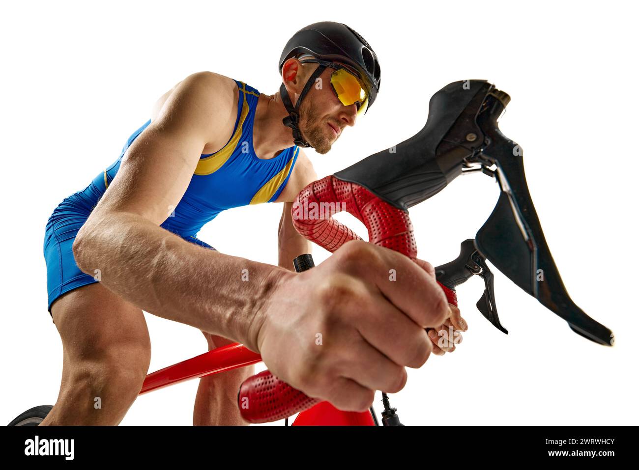 Competitive young man in blue uniform training, riding bicycle ...
