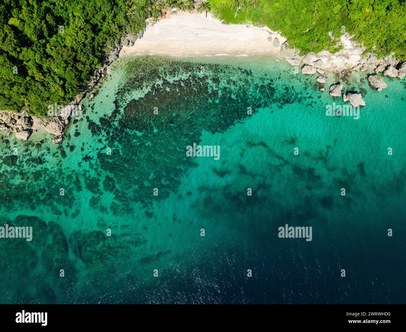 Aerial view of greenish water in coastal area with rocks. Carabao ...
