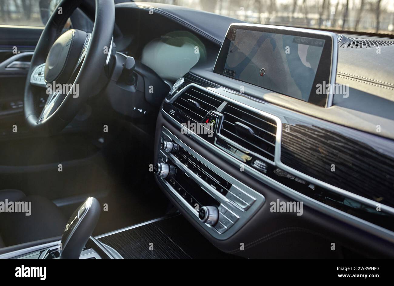 Shift lever, car steering wheel and sensors. Inside a modern car view ...