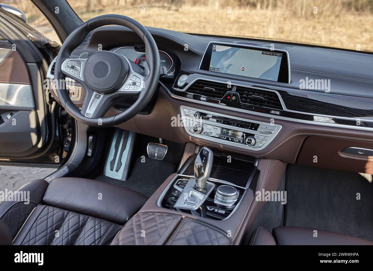 Shift lever, car steering wheel and sensors. Inside a modern car view ...