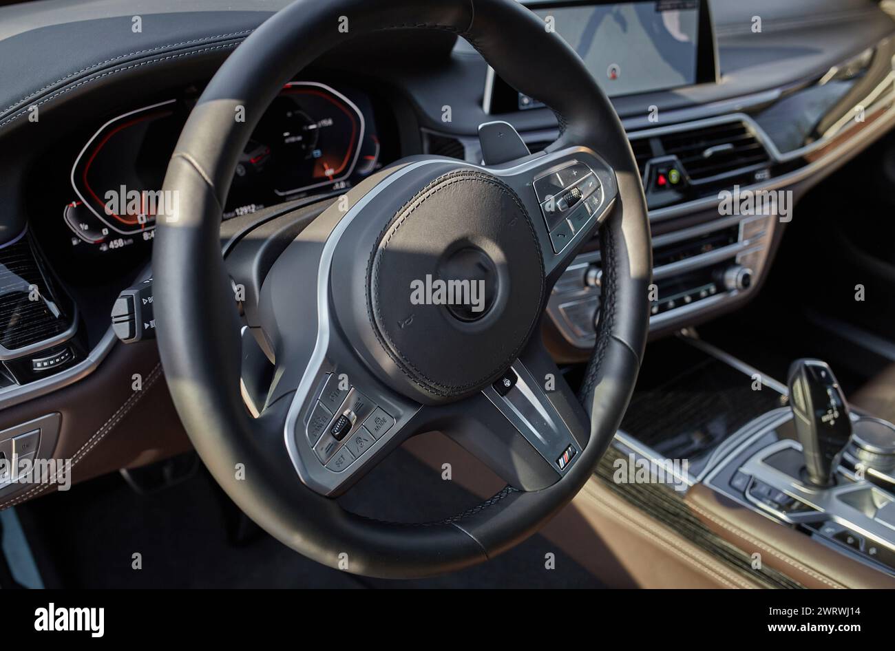 Shift lever, car steering wheel and sensors. Inside a modern car view ...