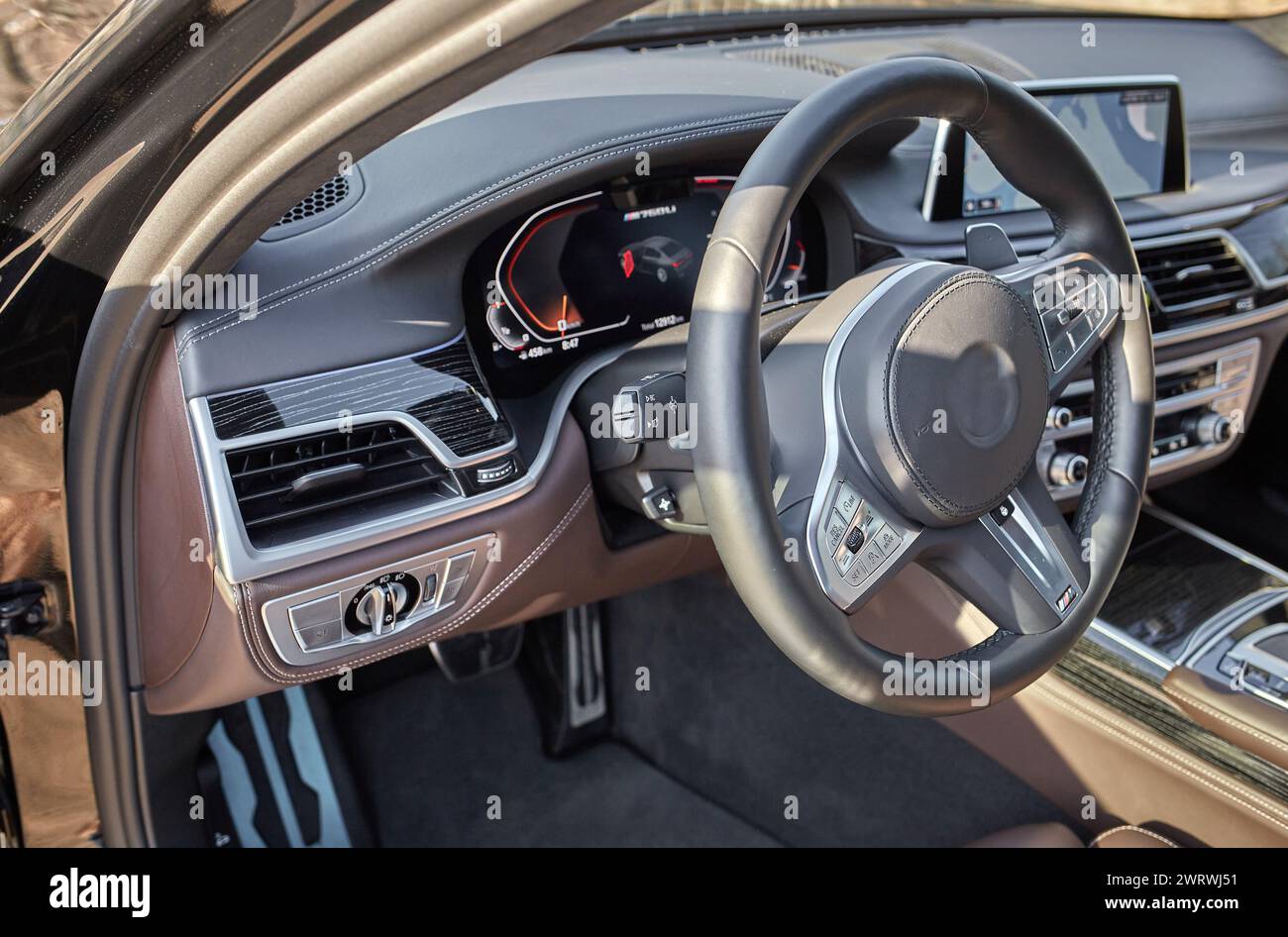 Shift lever, car steering wheel and sensors. Inside a modern car view ...