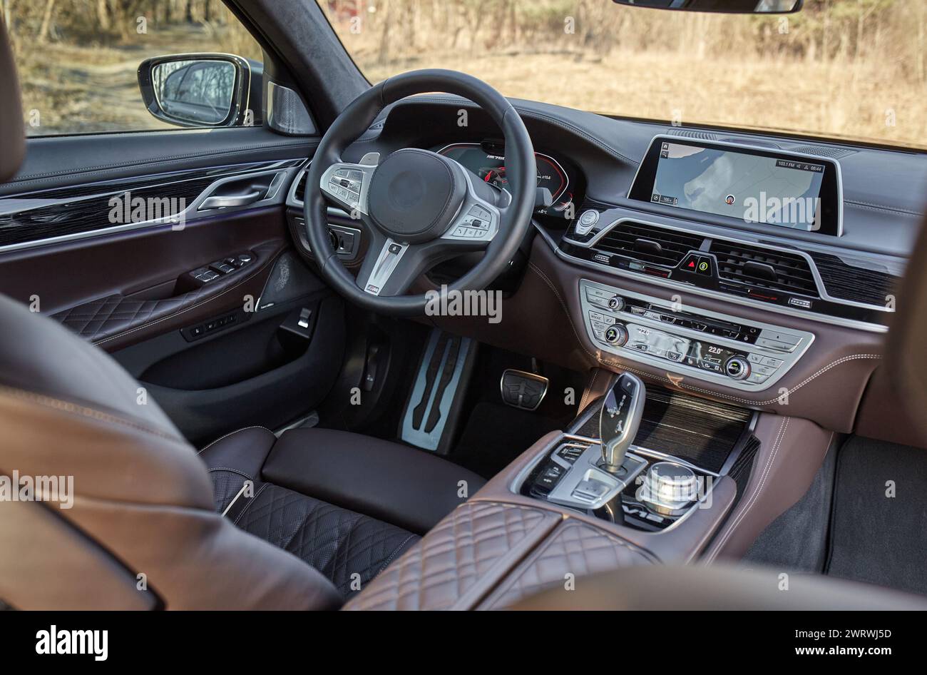 Shift lever, car steering wheel and sensors. Inside a modern car view ...