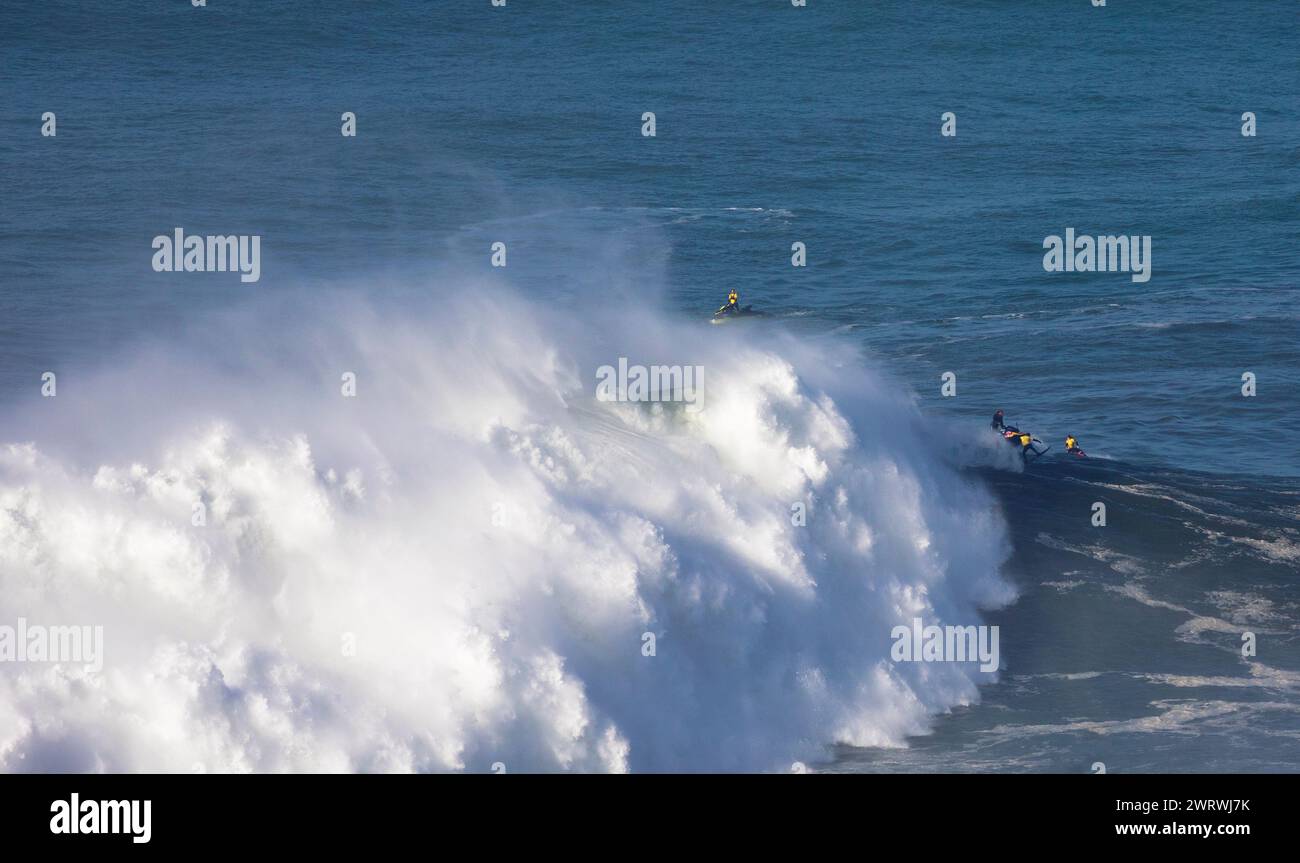 Portugal, Oeste Region, Nazaré, Surfer and support Jet Skis riding Huge ...