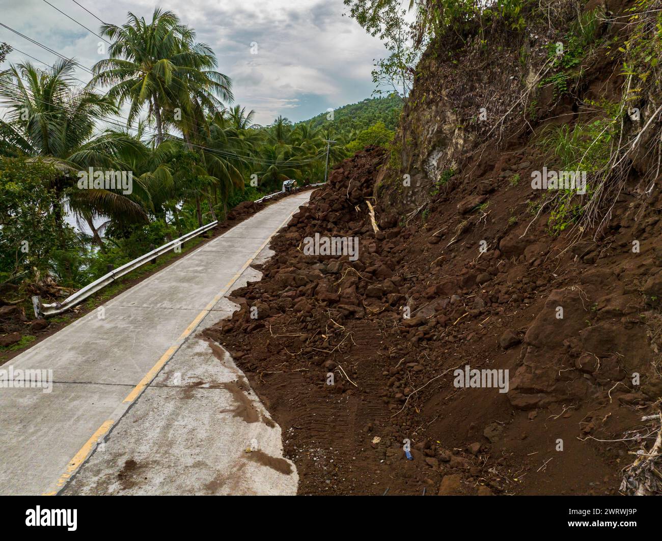 Landslides due to heavy rainfall block the mountain road. Philippines ...