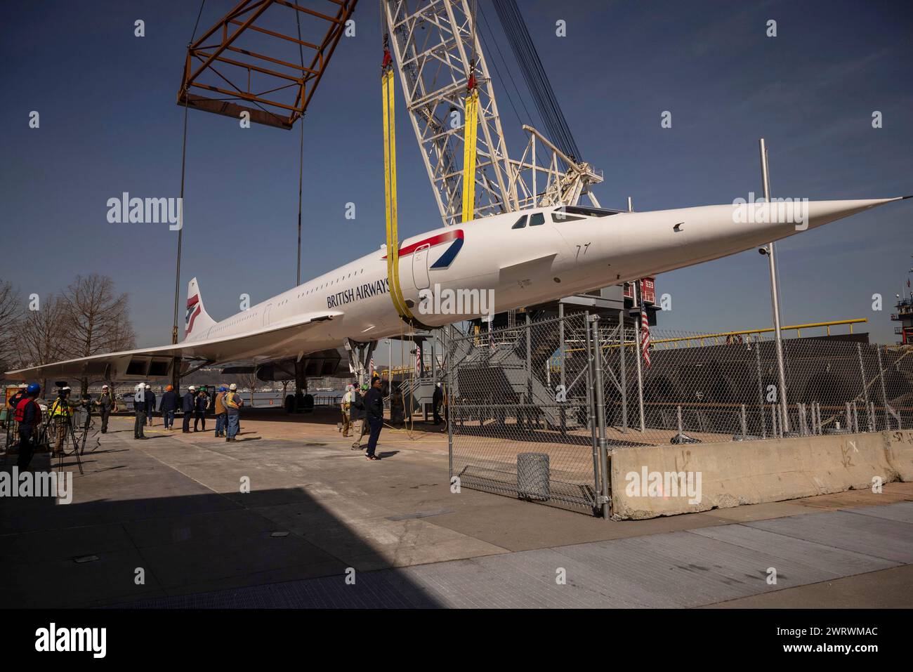 People watch a retired British Airways Concorde supersonic aircraft sit ...