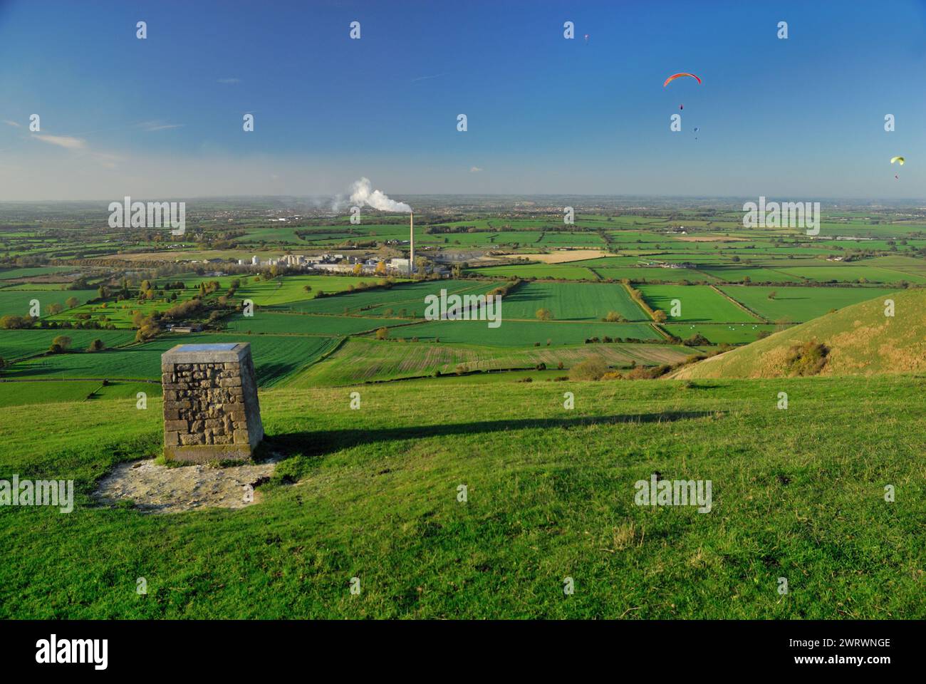 Hang-gliders and the cement works chimney seen from Westbury Hill ...