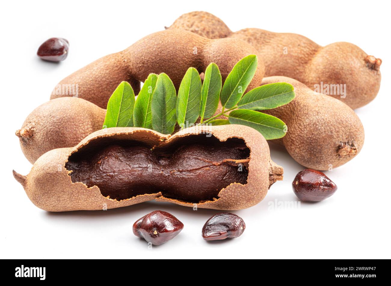 Ripe tamarind fruit, leaves and some tamarind seeds isolated on white ...