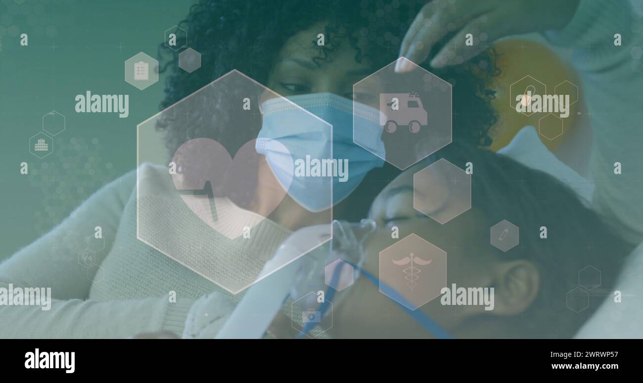 Image of medical icons over african american mother and daughter wearing face mask Stock Photo ...