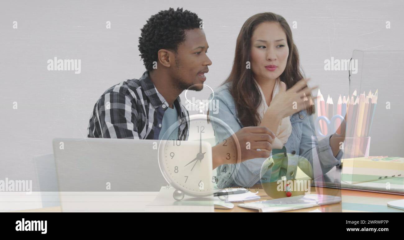 Image of clock over diverse business people talking Stock Photo - Alamy