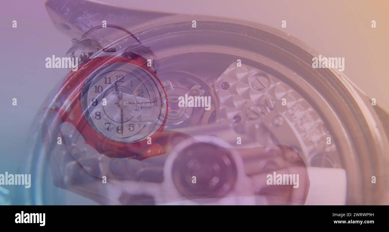 Image of clock over hand holding clock Stock Photo - Alamy
