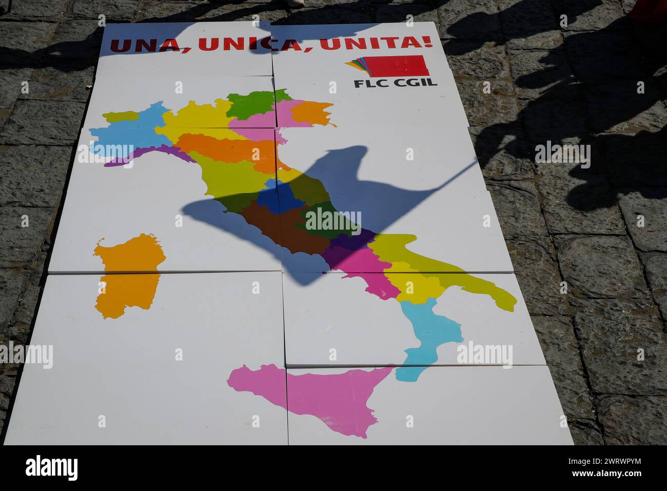 Naples, Italy. 14th Mar, 2024. The silhouette of a person holding a ...