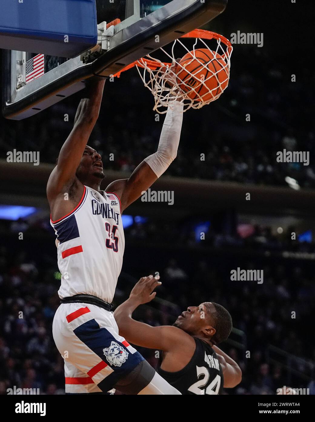 UConn's Samson Johnson (35) dunks the ball over Xavier's Abou Ousmane ...