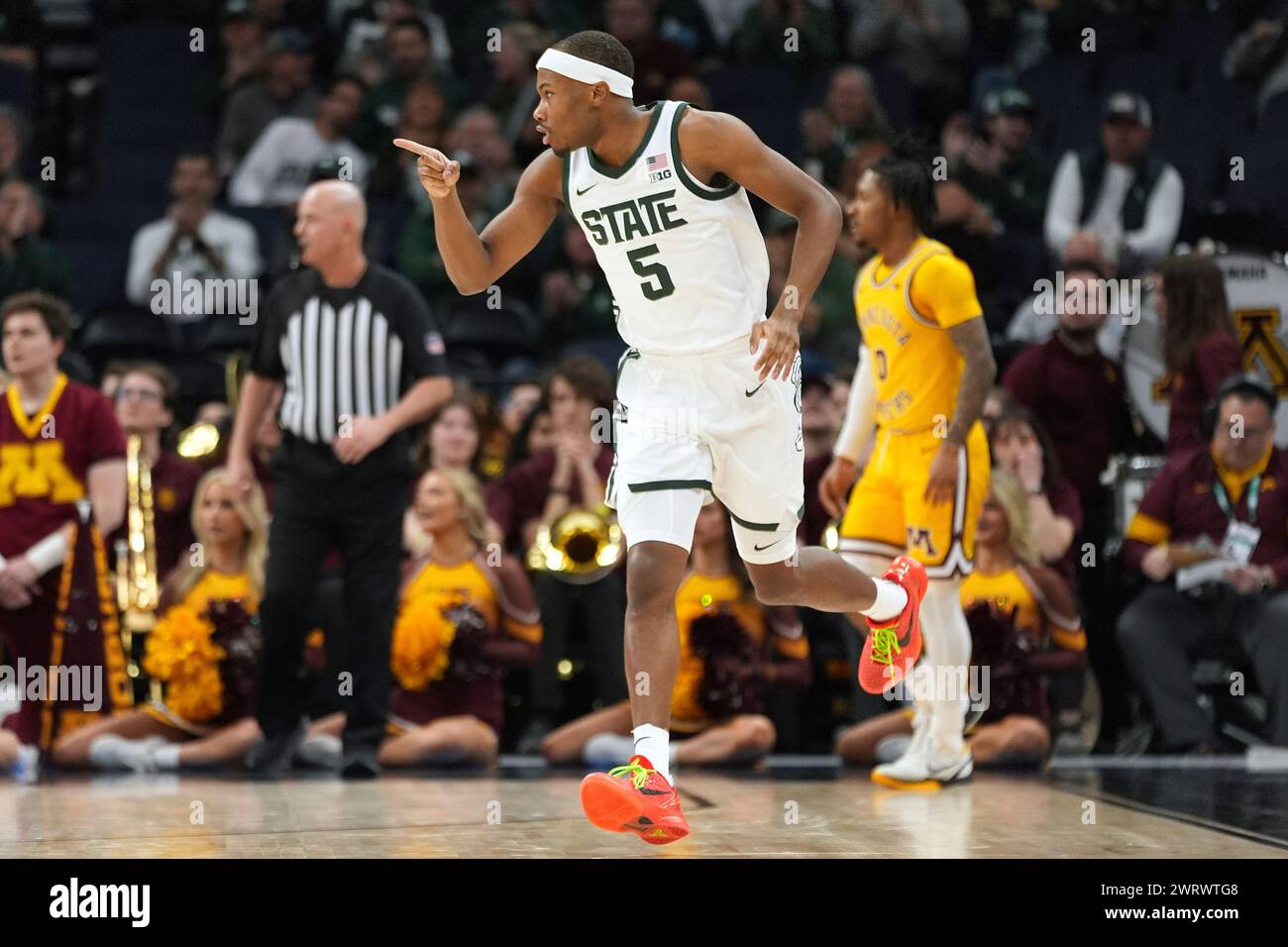 Michigan State guard Tre Holloman (5) points after making a 3-point basket during the first half ...