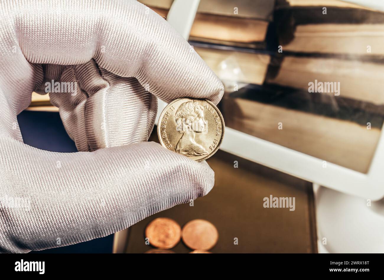 Photo of a person's male hand in white gloves holding a 20 cent 1975 ...