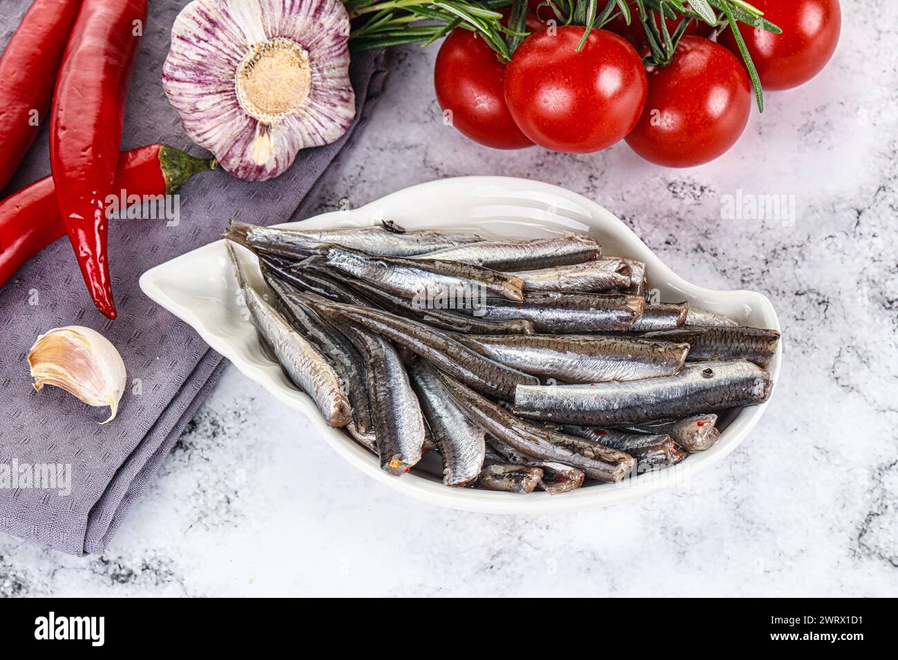 Pickled anchovy fish in the plate Stock Photo - Alamy