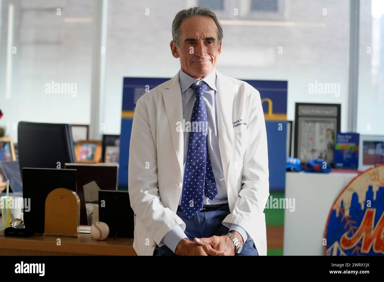 Dr. David Altchek poses for a picture in his office filled with sports ...