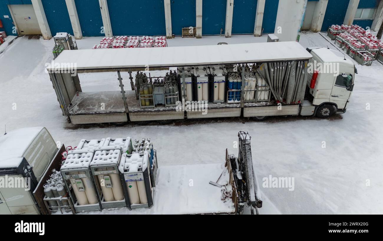 Drone photography of gas storage tanks in an open air warehouse being ...
