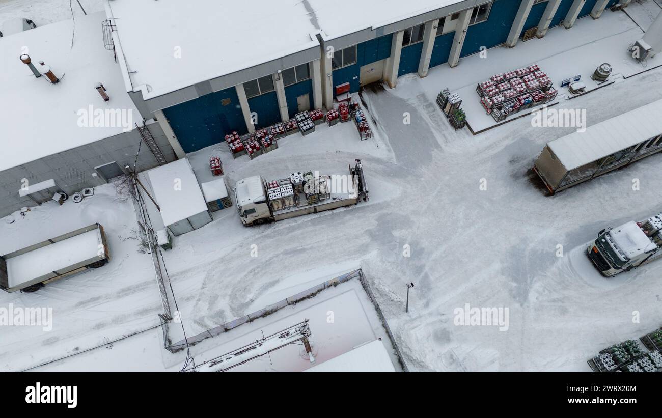 Drone photography of gas storage tanks in an open air warehouse being ...