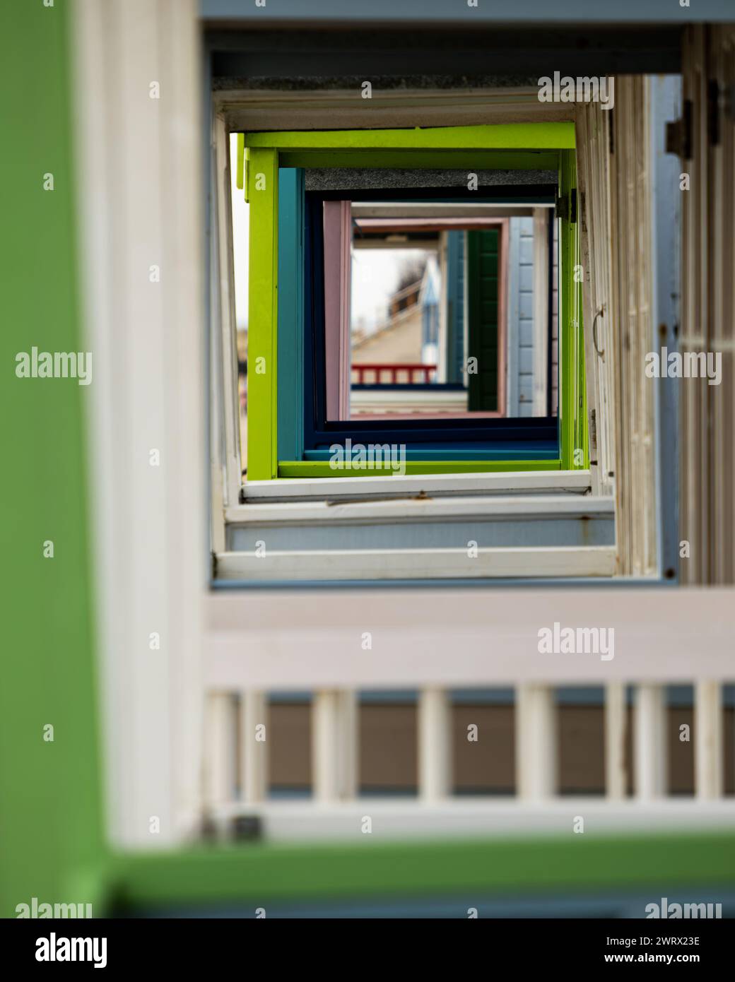 A sideways view through the front porch of a row of colourful beach ...