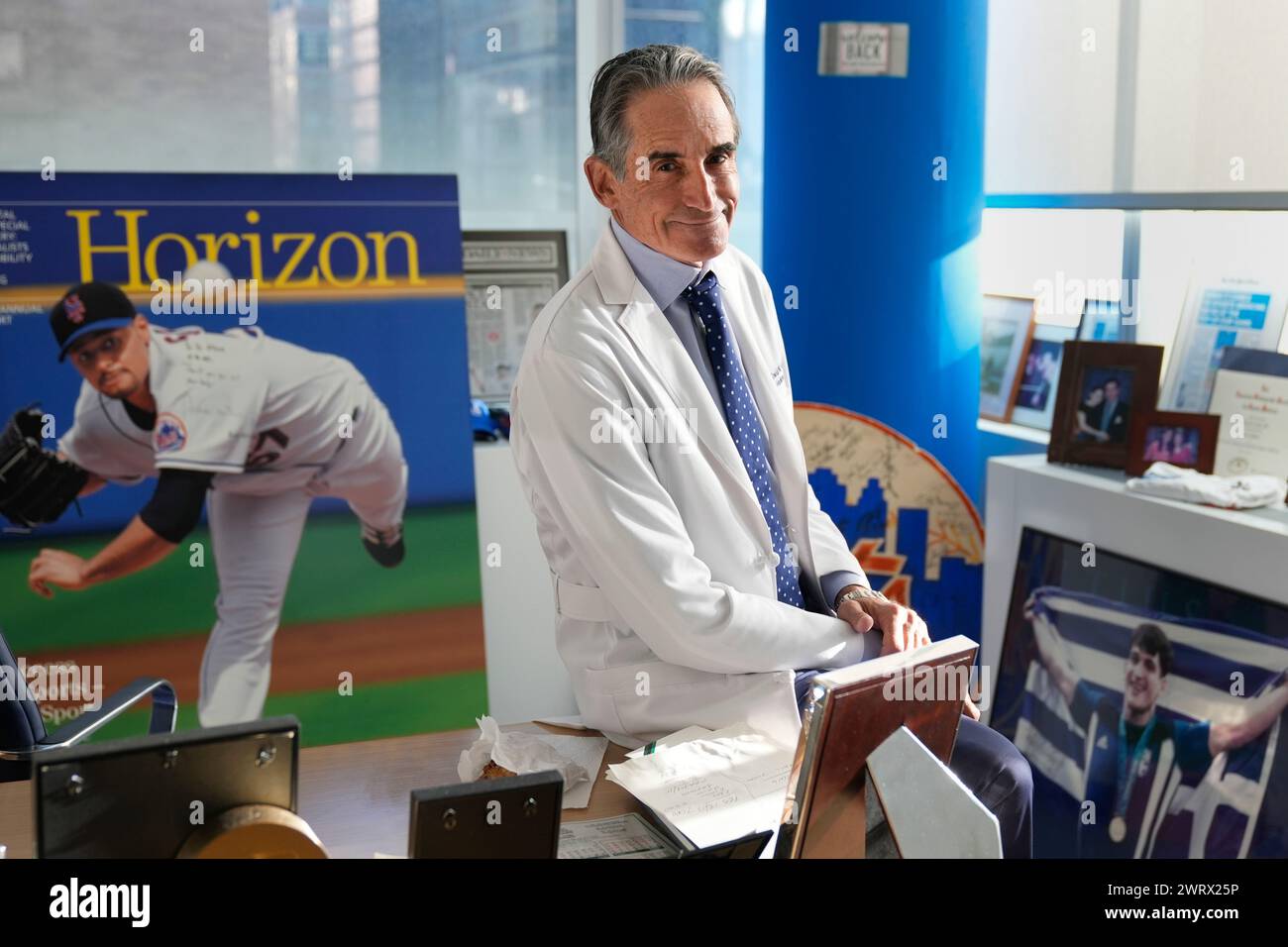 Dr. David Altchek poses for a picture in his office filled with sports ...