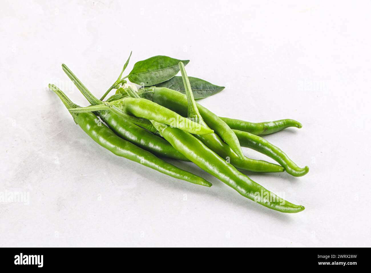 Spicy green chili pepper seasoning heap Stock Photo - Alamy