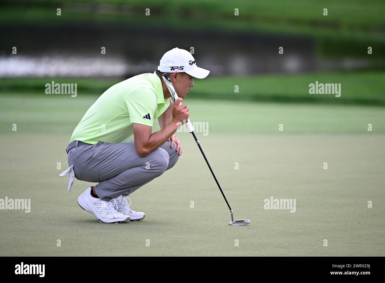 Collin Morikawa lines up his putt on the 17th green during the second ...