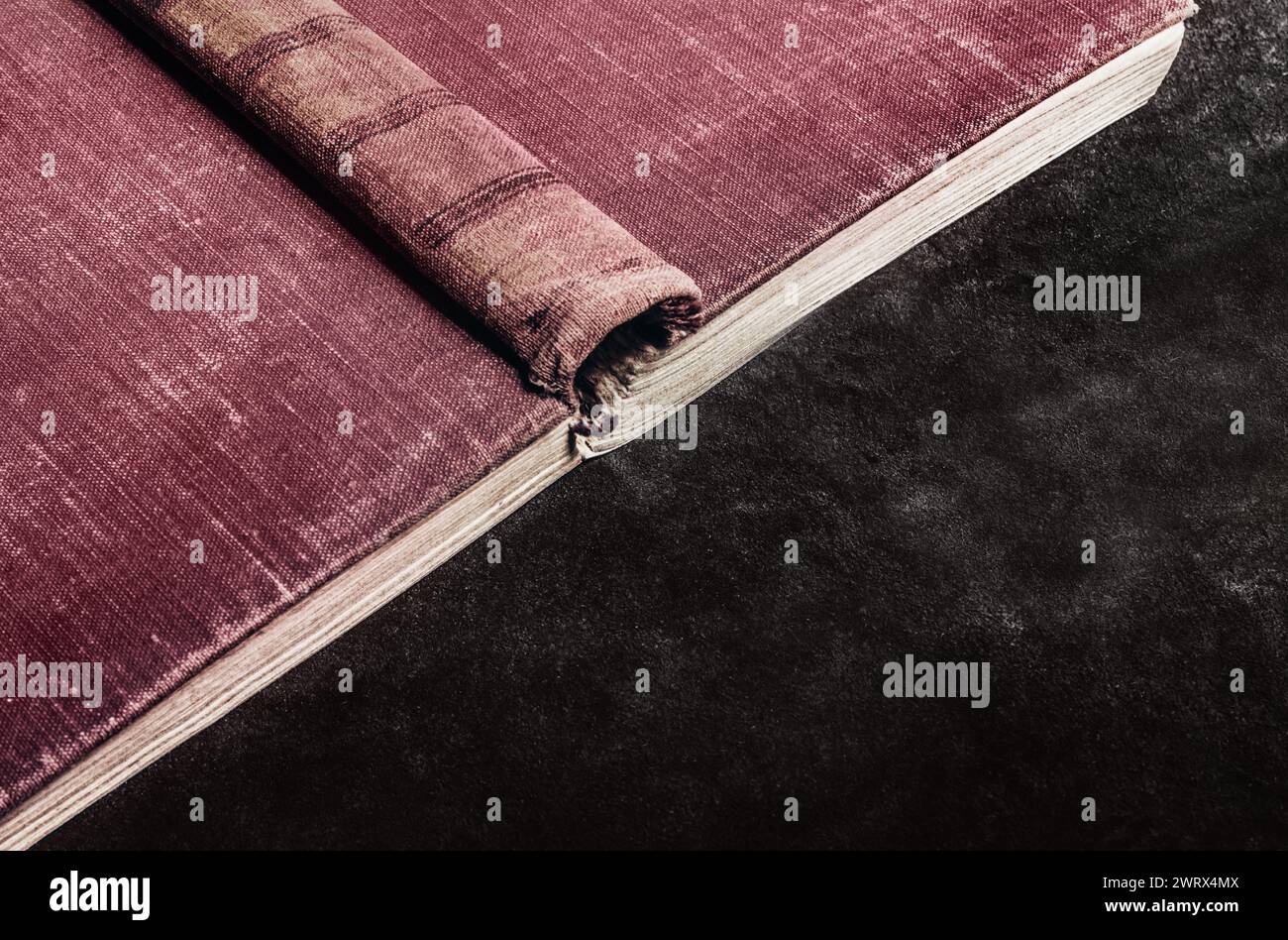 Photo of old antique opened red colored book laying on leather table ...